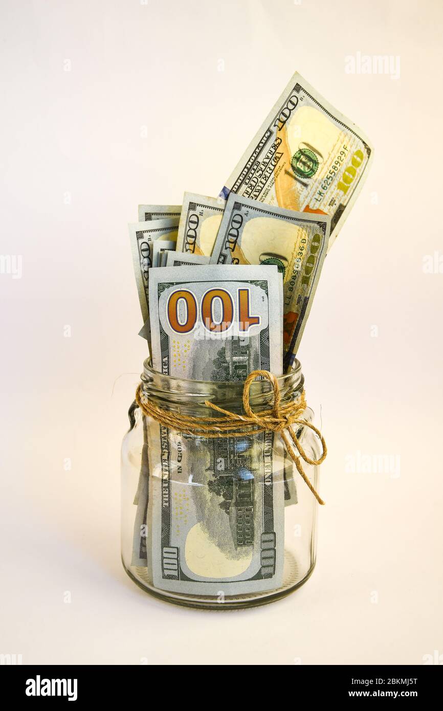 Glass jars filled with dollar bills, savings inside glass jar, money ...