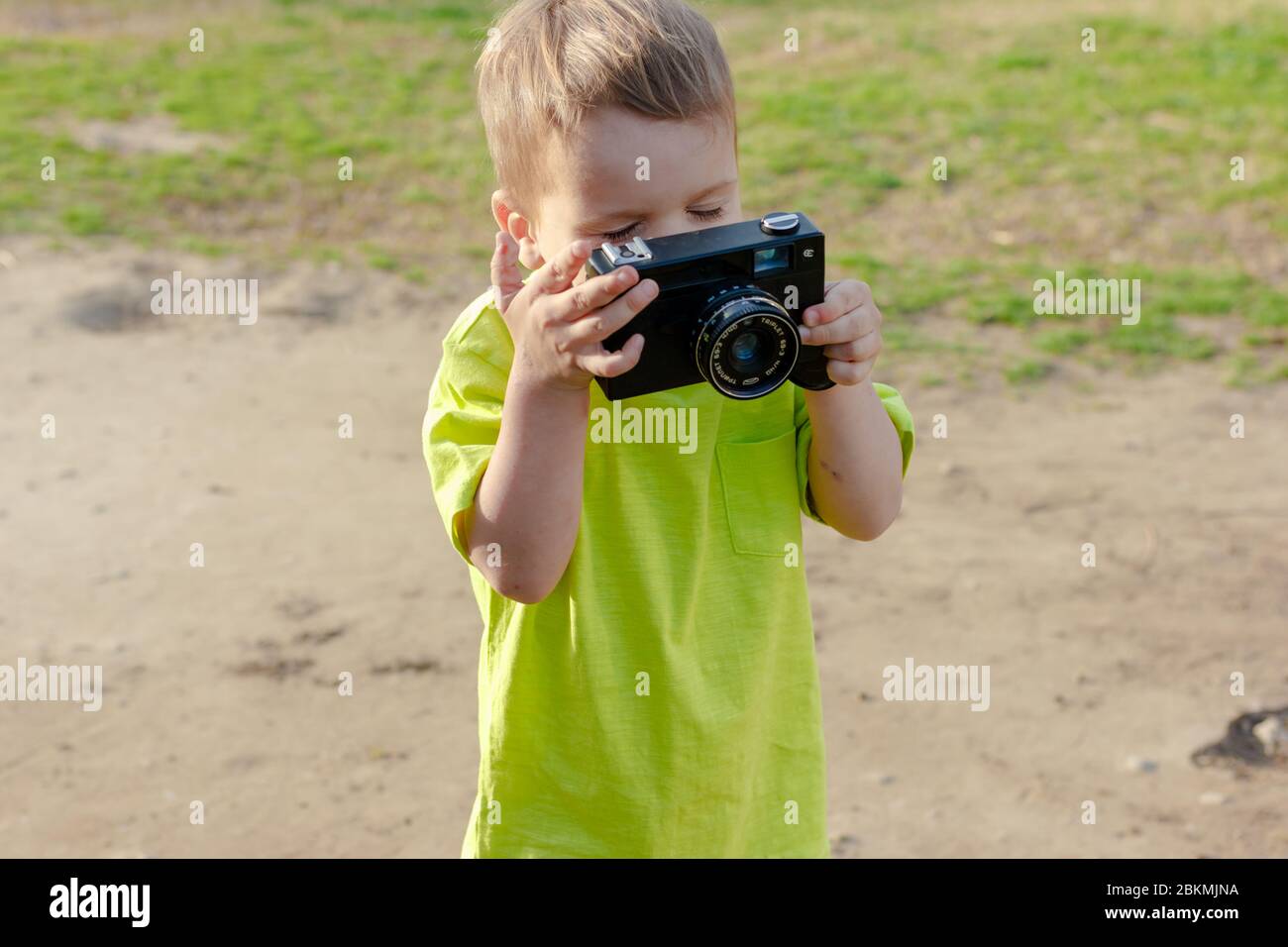 Little boy using vintage camera. Cute caucasian child taking photo with ...