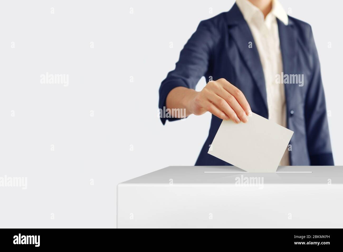 Woman putting a ballot into a voting box Stock Photo - Alamy