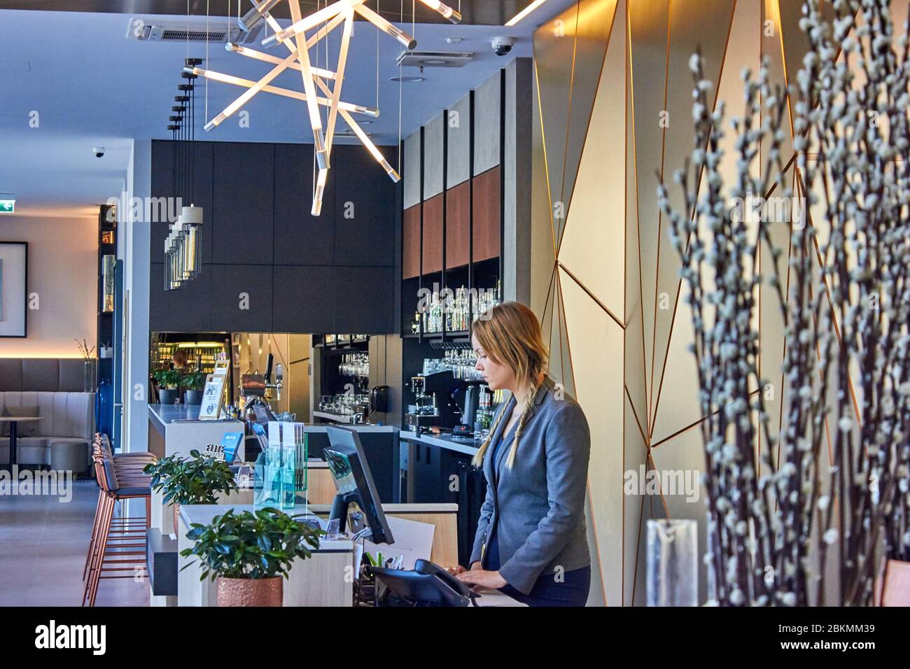 Young woman in hotel lobby waiting for the guests Stock Photo - Alamy