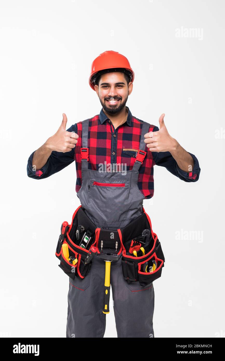 Portrait of happy handyman with tools showing thumbs up sign isolated ...