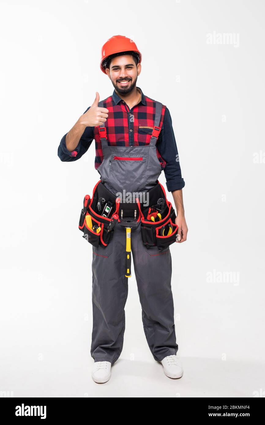 Portrait of happy handyman with tools showing thumbs up sign isolated ...