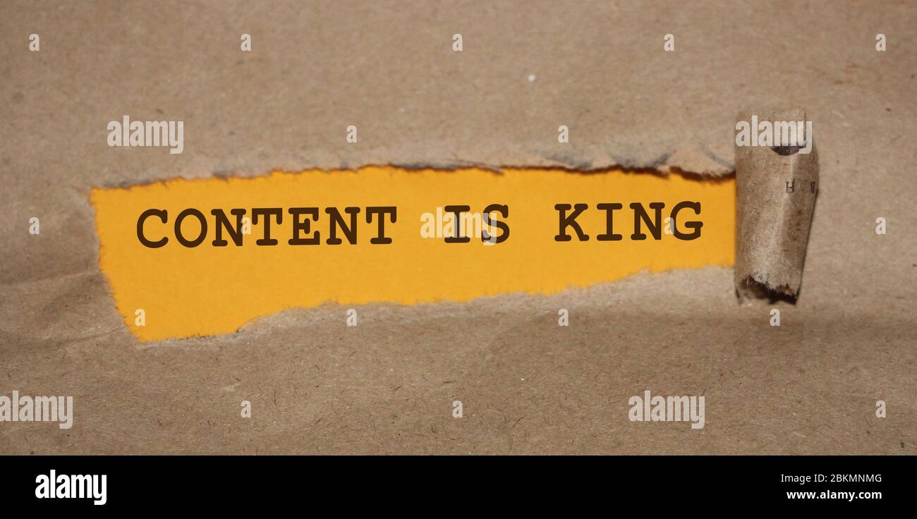 Content is king -message written under torn paper. Corywriting ...