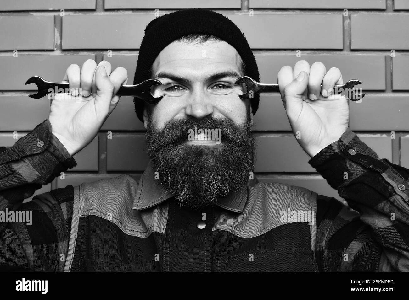 Bearded man, long beard. Brutal caucasian smiling happy mechanic ...