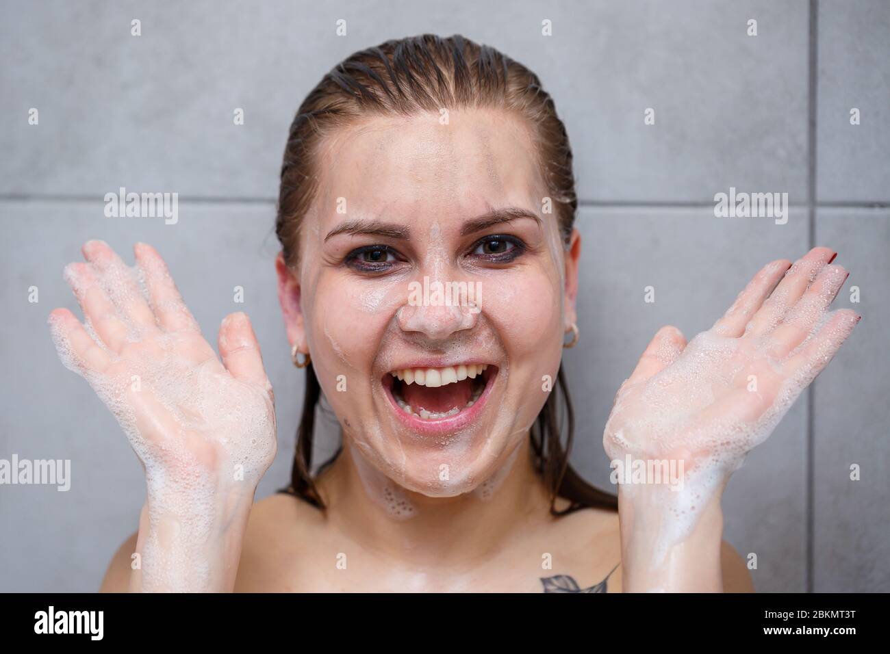 Face skin care. Woman applying facial cleanser on face closeup. Girl ...
