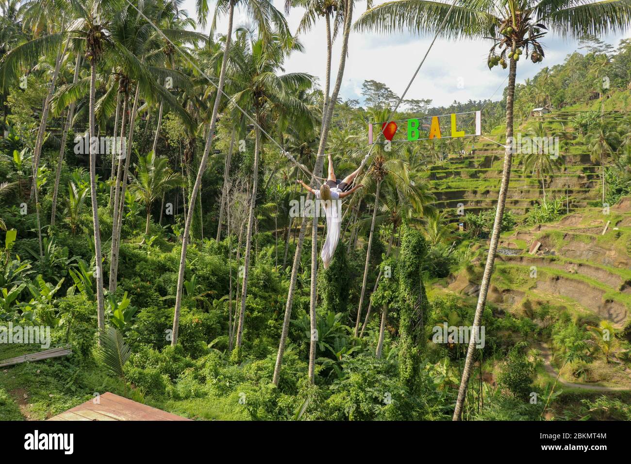Girl swinging on a rope bali hi-res stock photography and images - Alamy