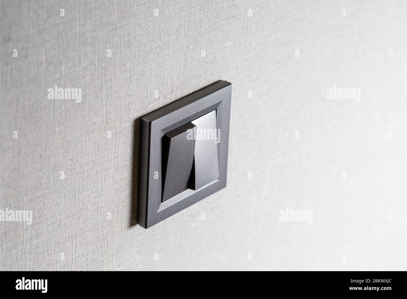 Two-key switch gray on the wall a plastic mechanical switch. Light ...