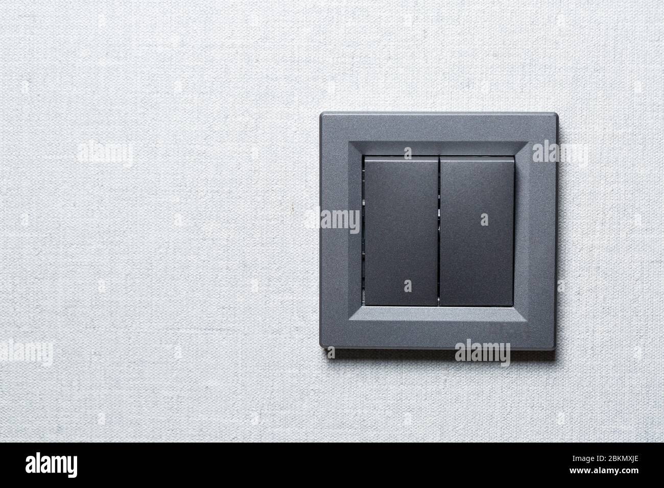 Two-key switch gray on the wall a plastic mechanical switch. Light ...