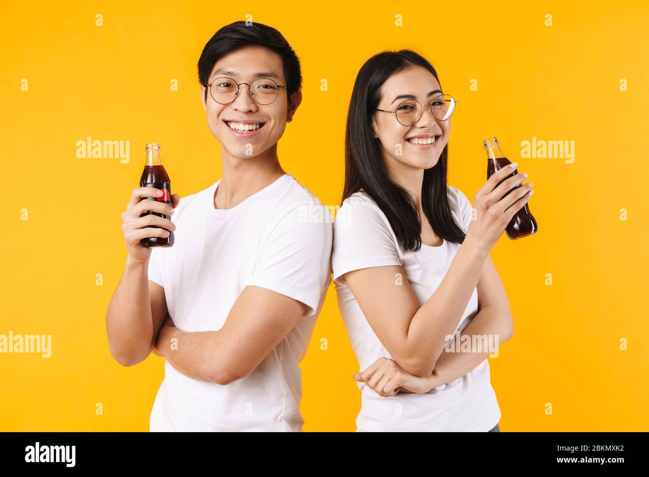 Image of funny multinational couple drinking soda and smiling isolated ...