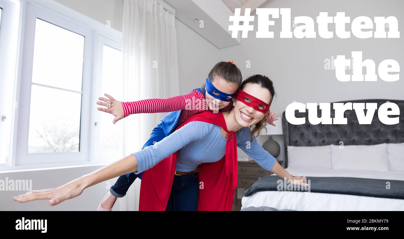 Caucasian woman wearing cape holding her daughter with words #Flatten ...