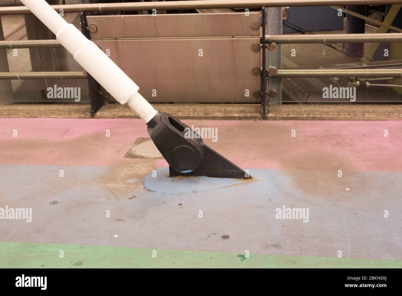 A close-up view of an industrial mechanical joint on a colored surface ...