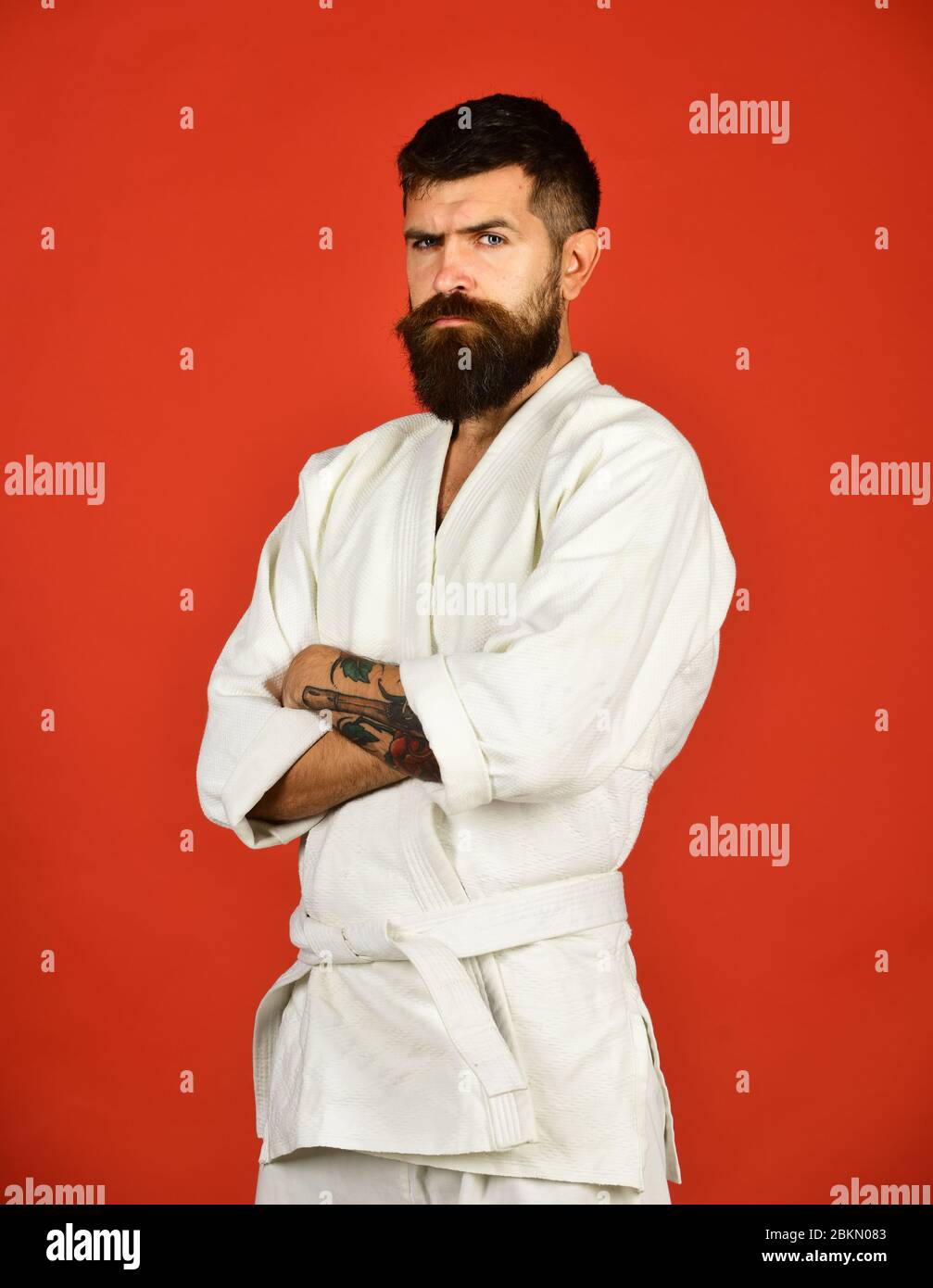 Judo master holds arms crossed. Karate man with strict and serious face ...