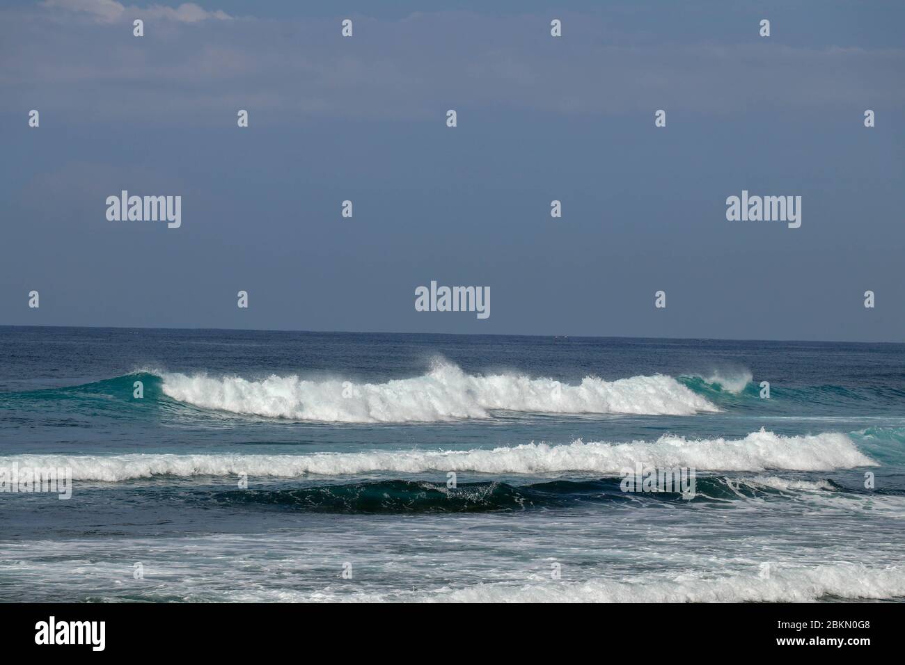 Big breaking wave with glowing green water and big white spray and foam ...