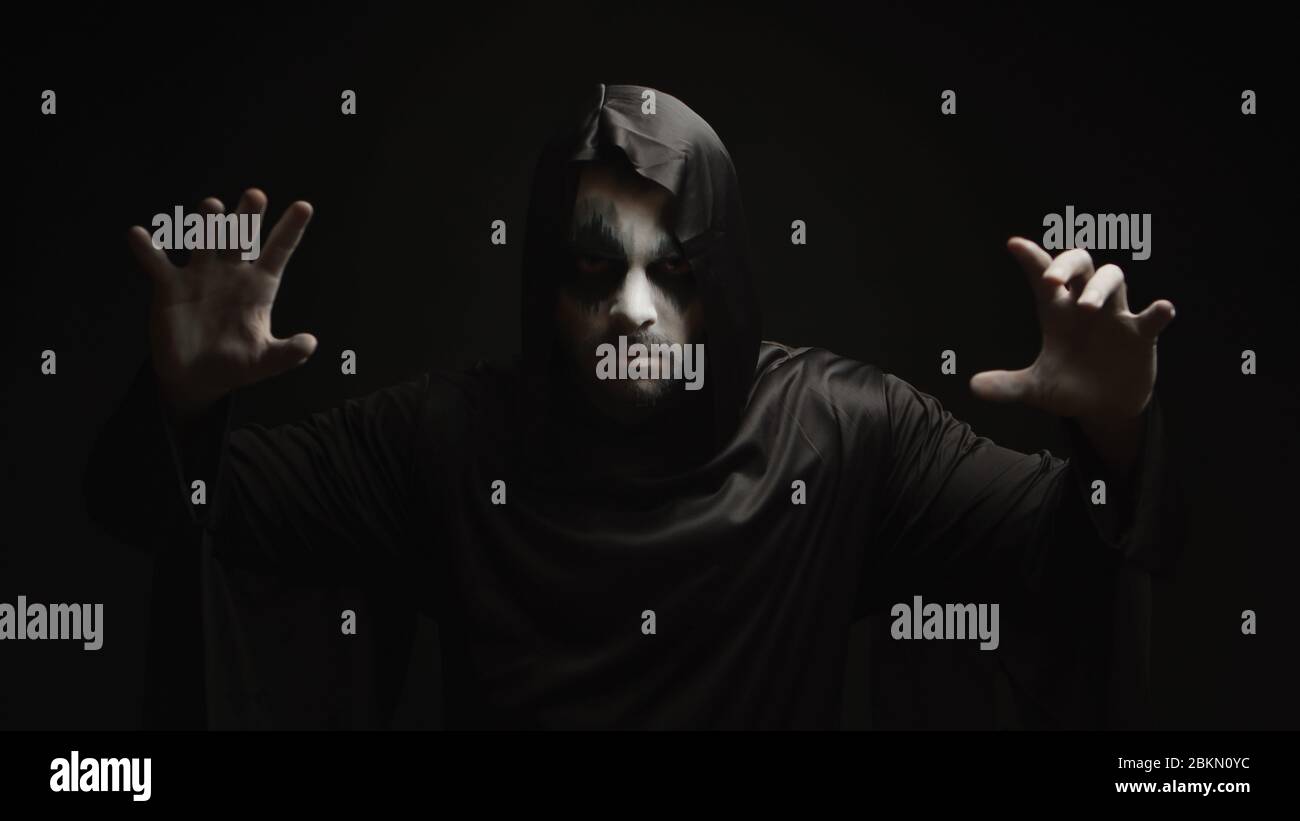 Dangerous hell demon doing magic over black background. Halloween ...