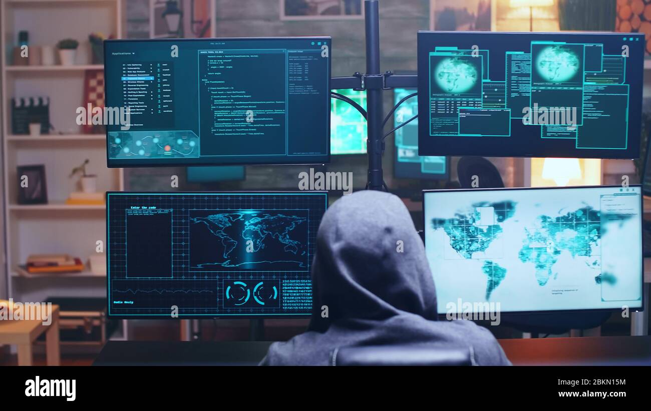 Back view of cyber terrorist using supercomputer to hack government ...