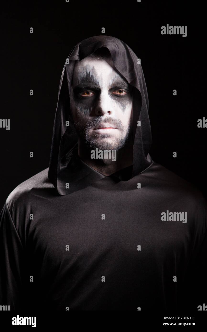 Grim reaper with a hood isolated over black background. Halloween ...