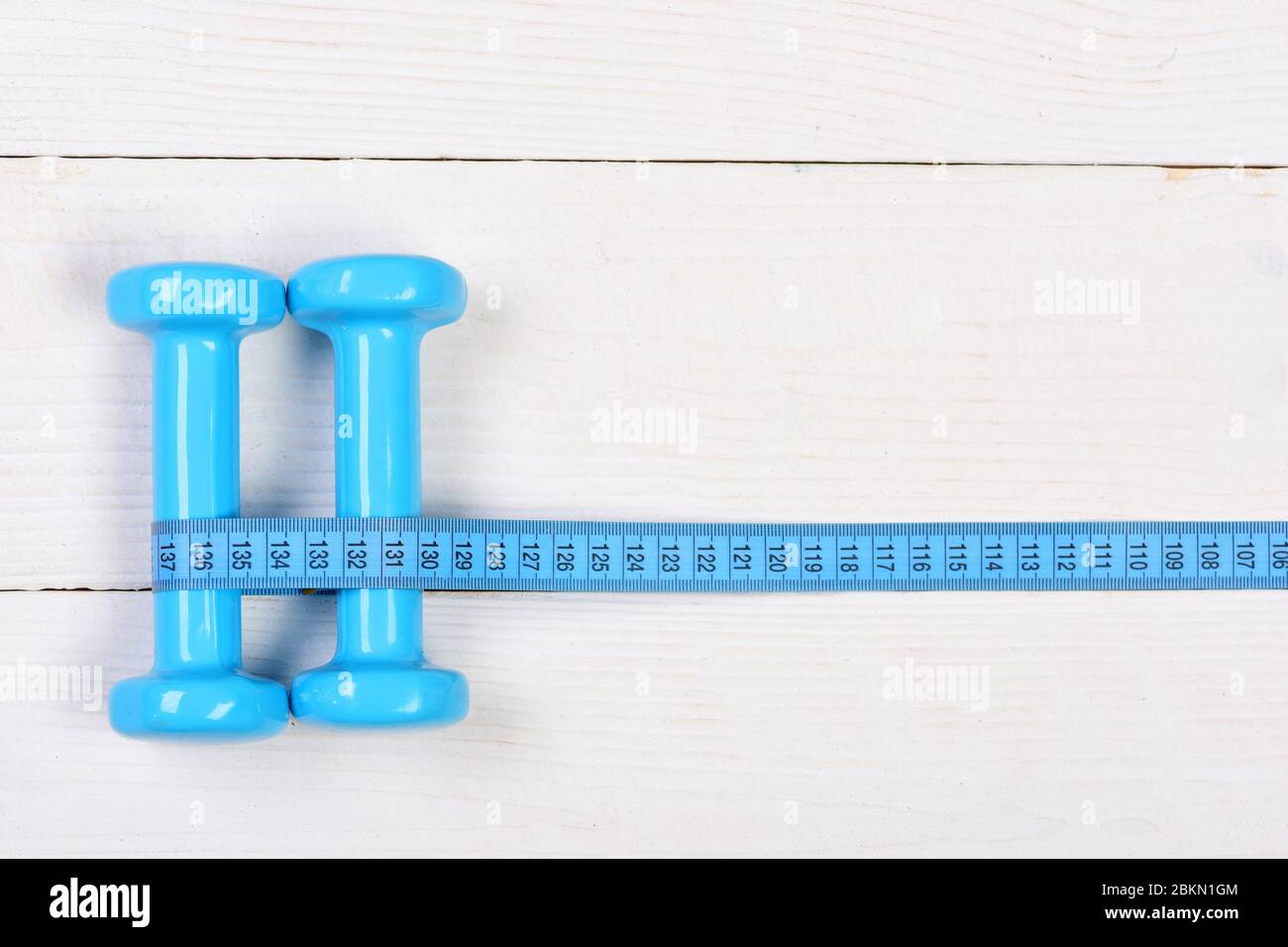 Barbells top view on white background. Measuring tape and sports ...