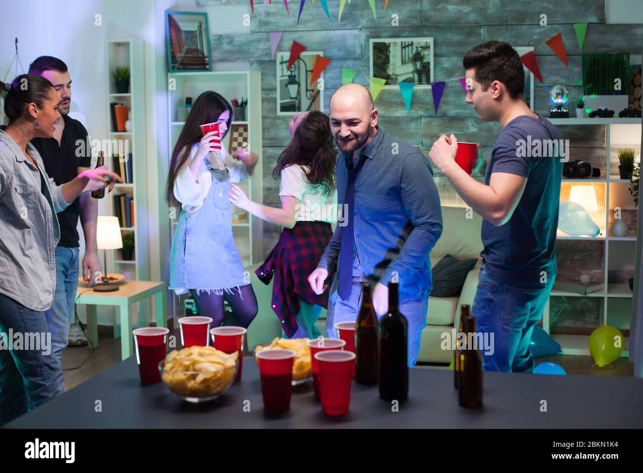Handsome bald man dancing while partying with his best friends Stock ...