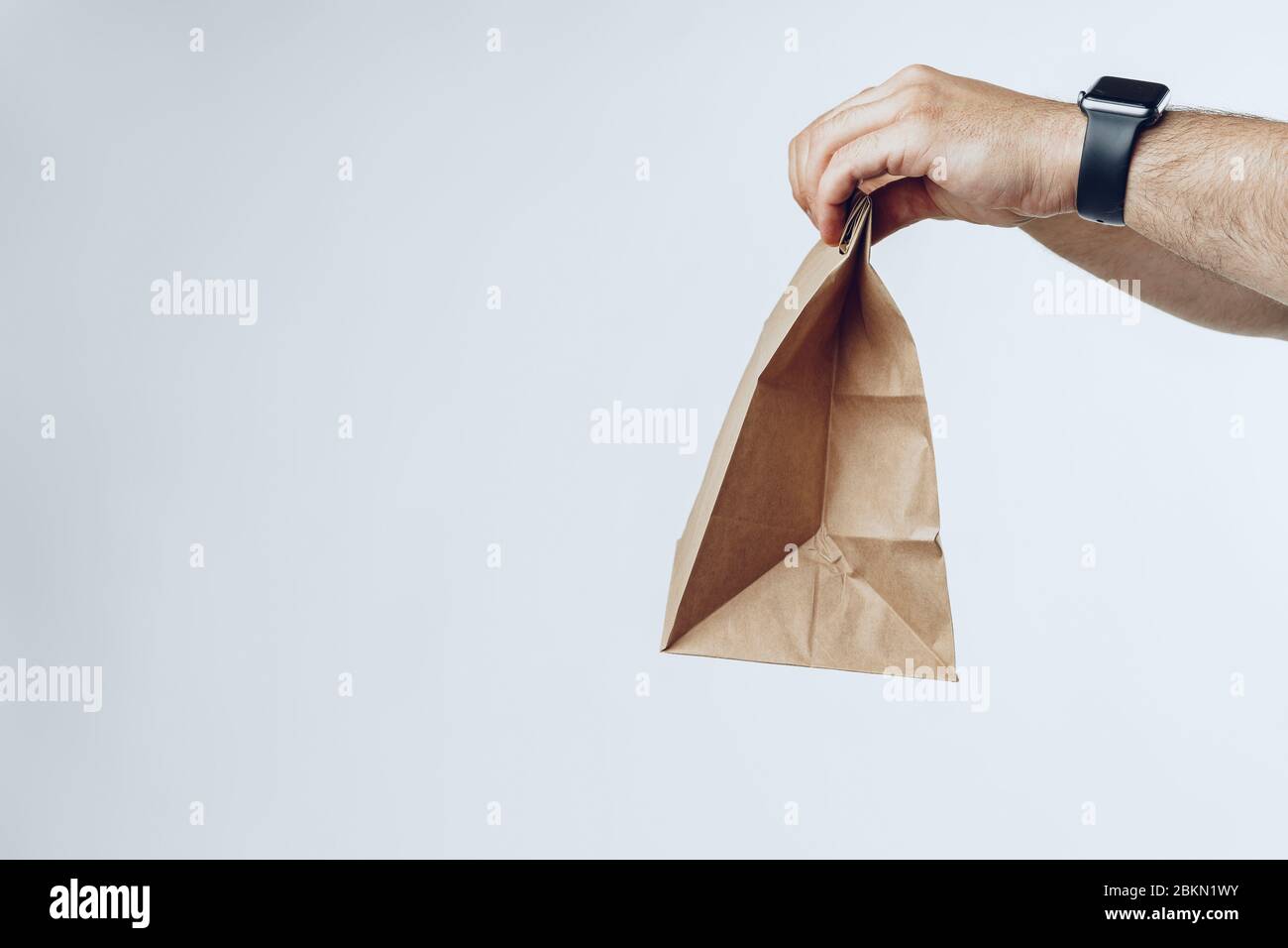 Courier hands giving packed food delivery close up Stock Photo - Alamy