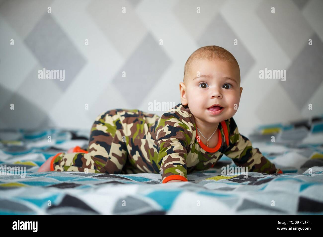 portrait of a little boy age 8 months and is smiling. Health and ...