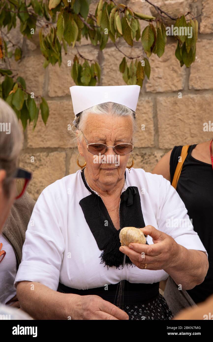 Konavle, Croatia, September 5th 2019. An elderly woman wearing a ...
