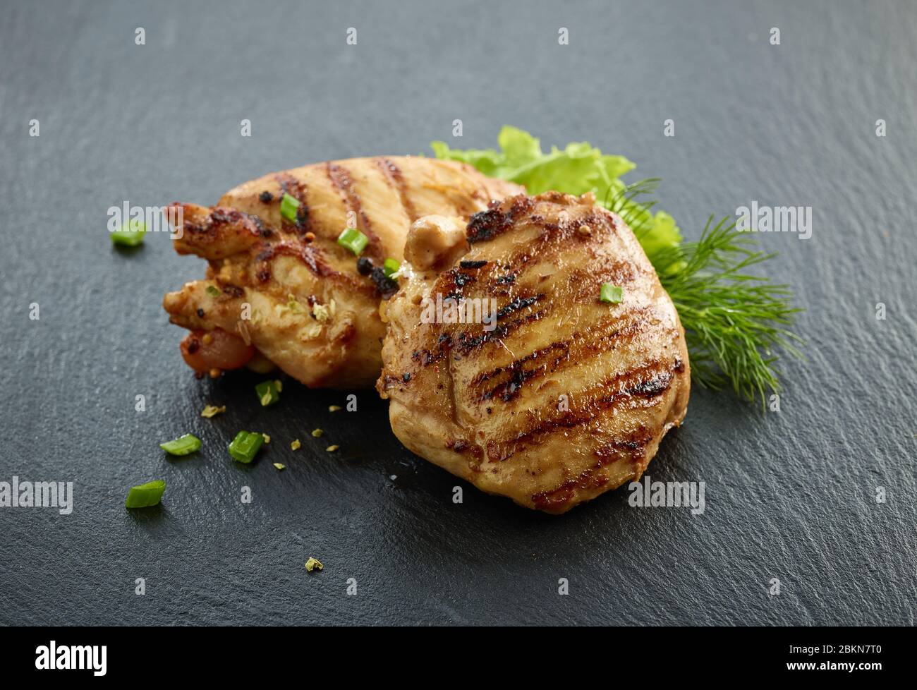 grilled chicken ham meat on black background Stock Photo - Alamy