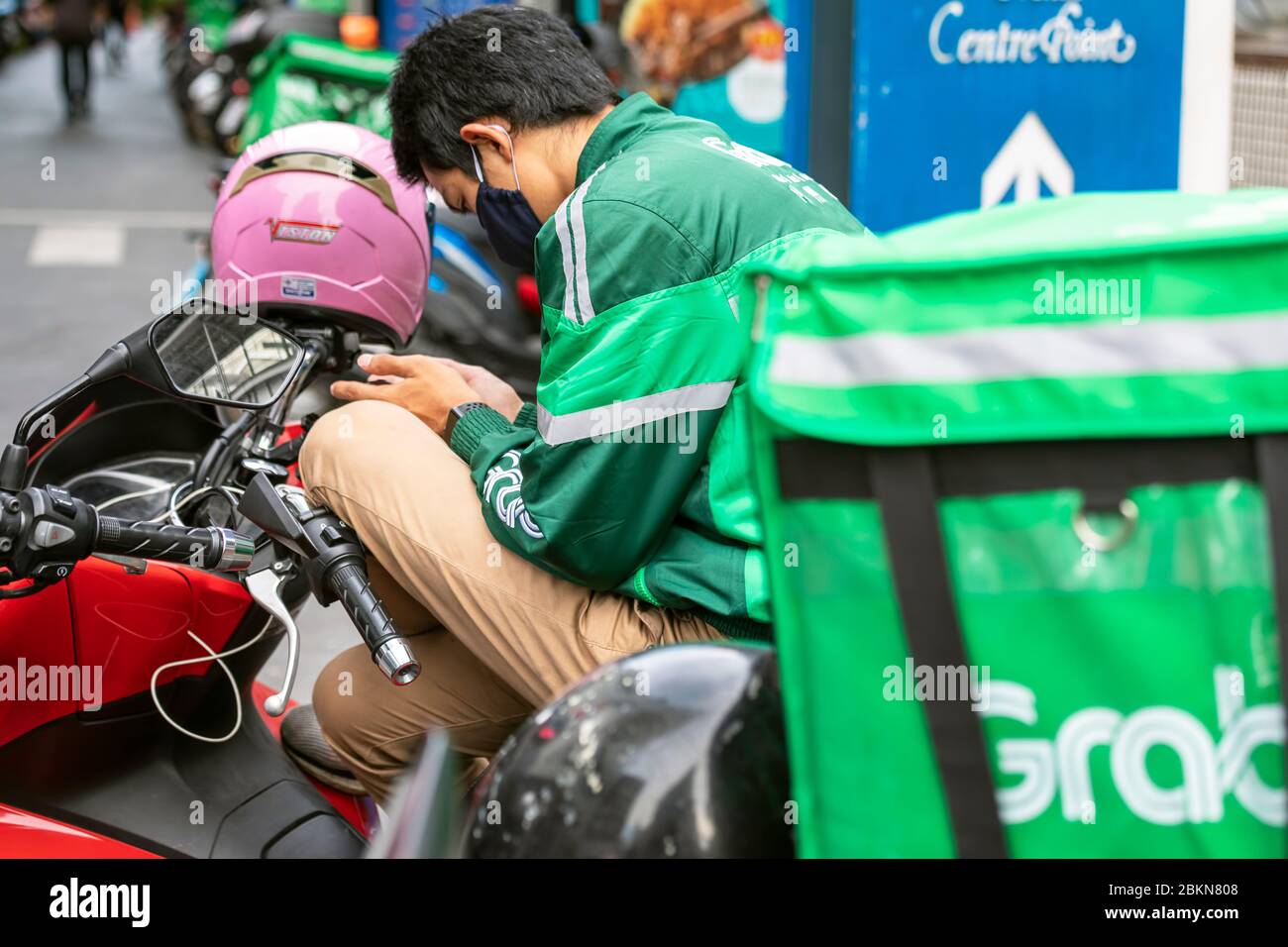 Grab food delivery motorcycle rider with face mask during Covid 19 ...
