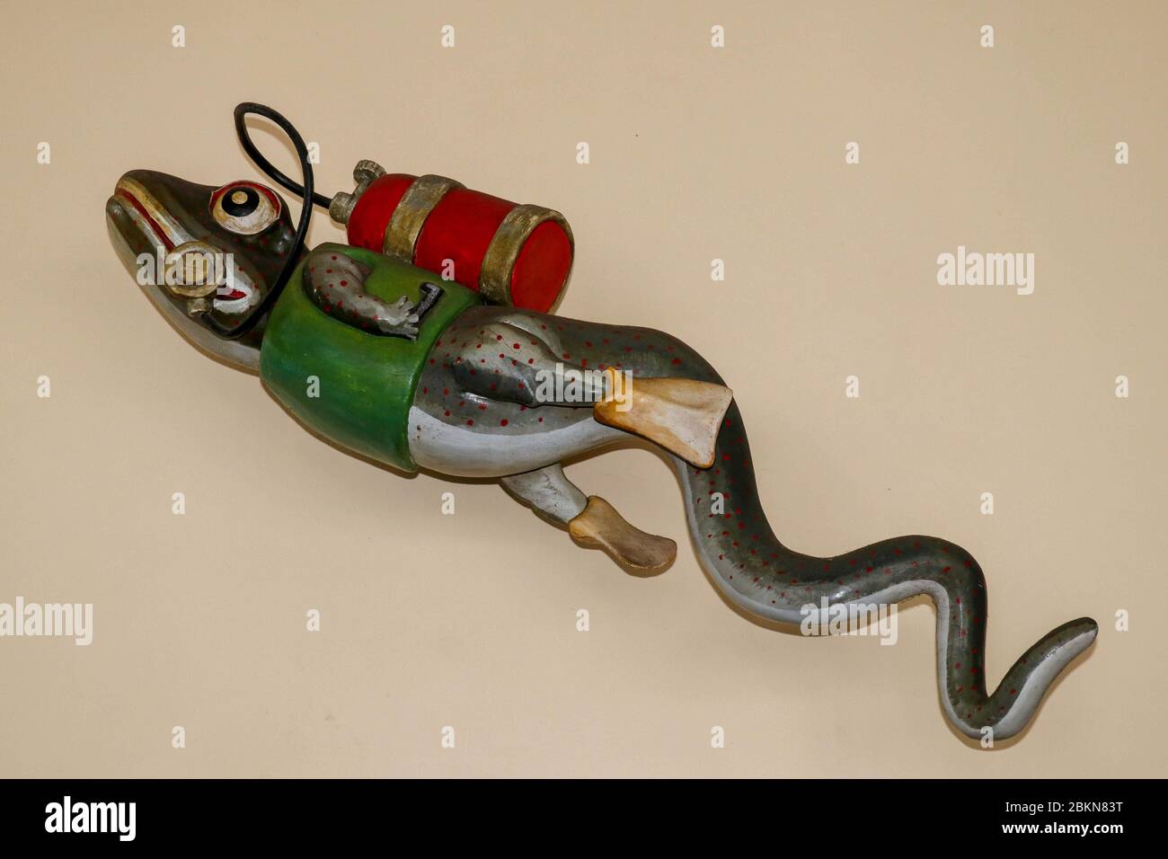 Statue of gecko with diving equipment on the wall of diving center. 3D ...
