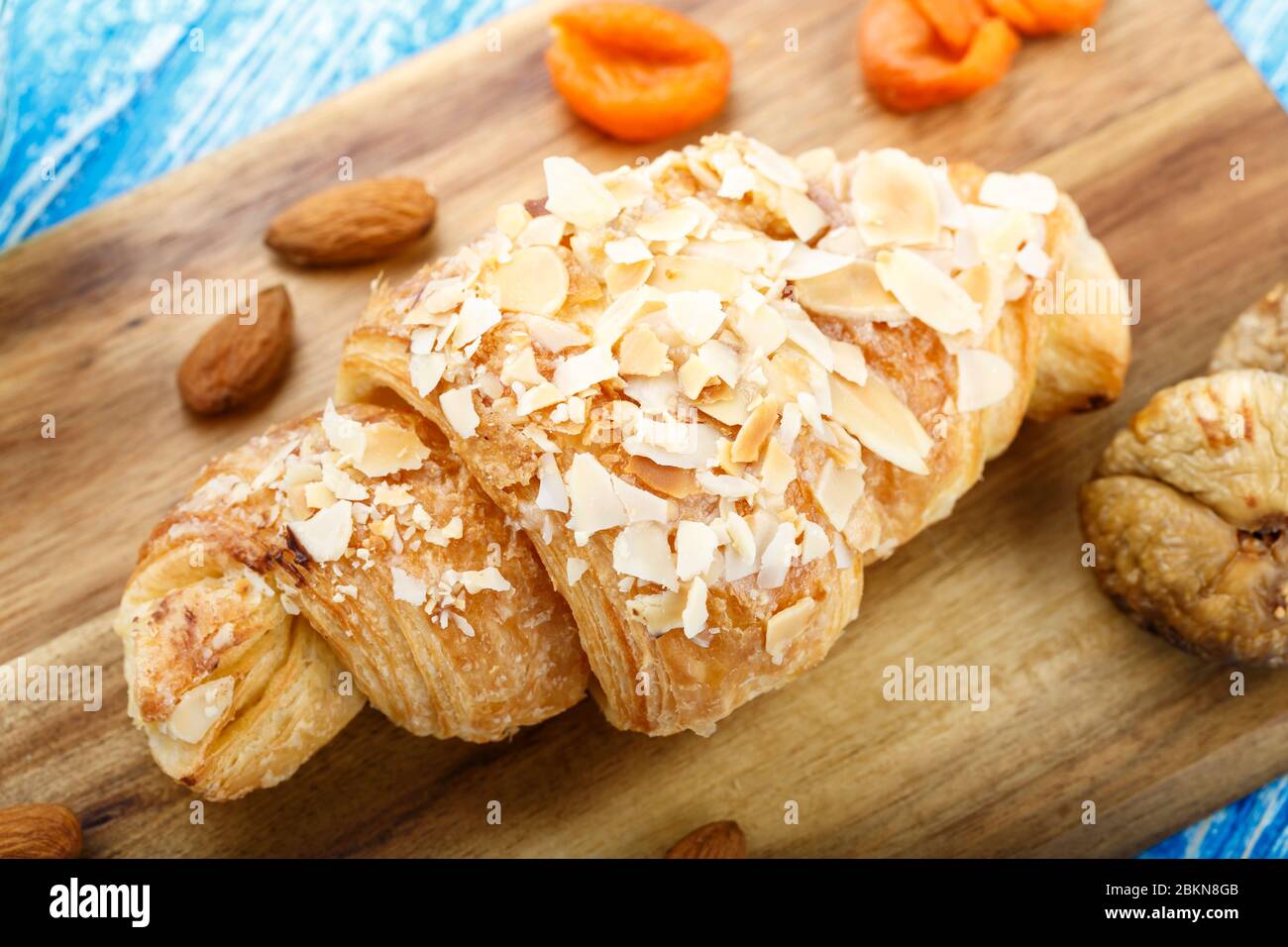 Fresh croissant and dried fruits on the table. traditional carbohydrate ...