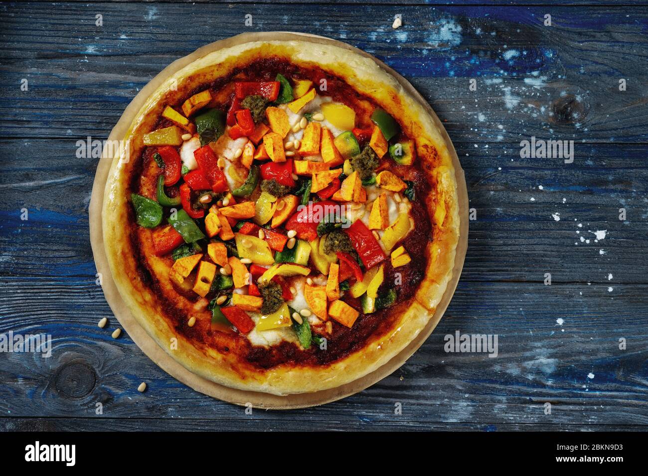 Top view of delicious vegan pizza on dark blue background Stock Photo ...