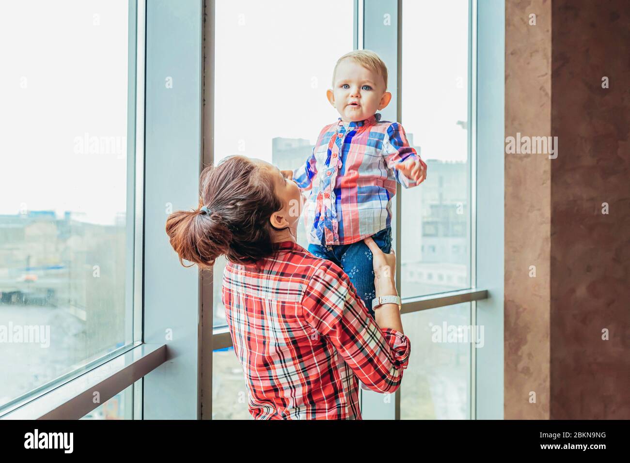 Stay Home Stay Safe. Young mother holding her child. Woman and infant ...