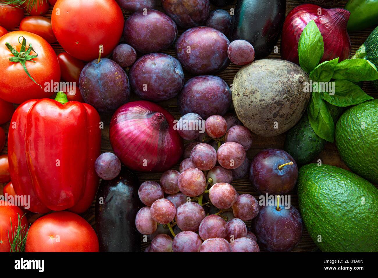 Colorful red, green and violet fruits and vegetables, top view, close ...