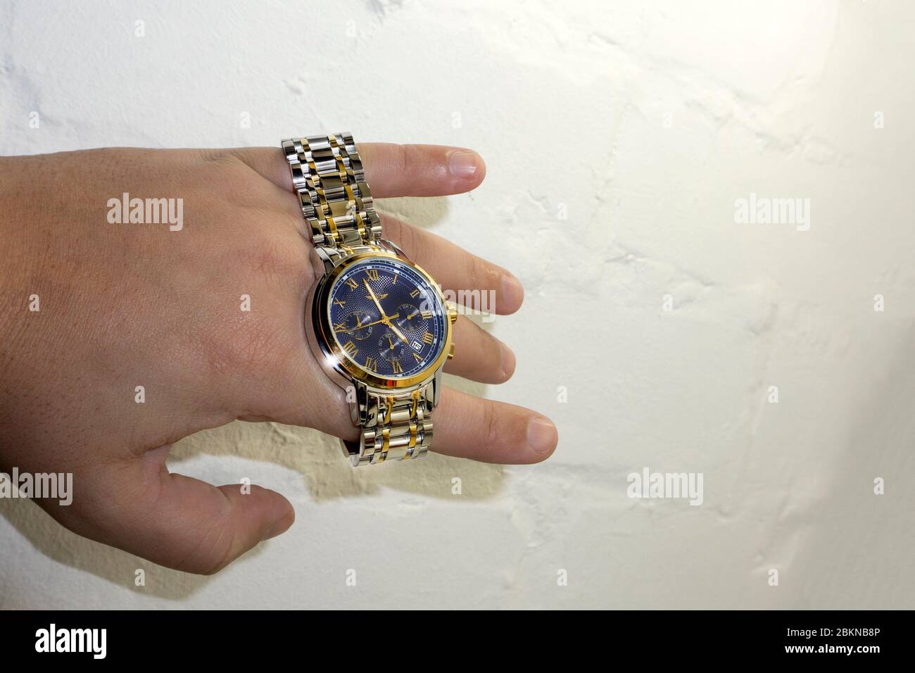 a man's hand shows off a watch with a clock Stock Photo - Alamy