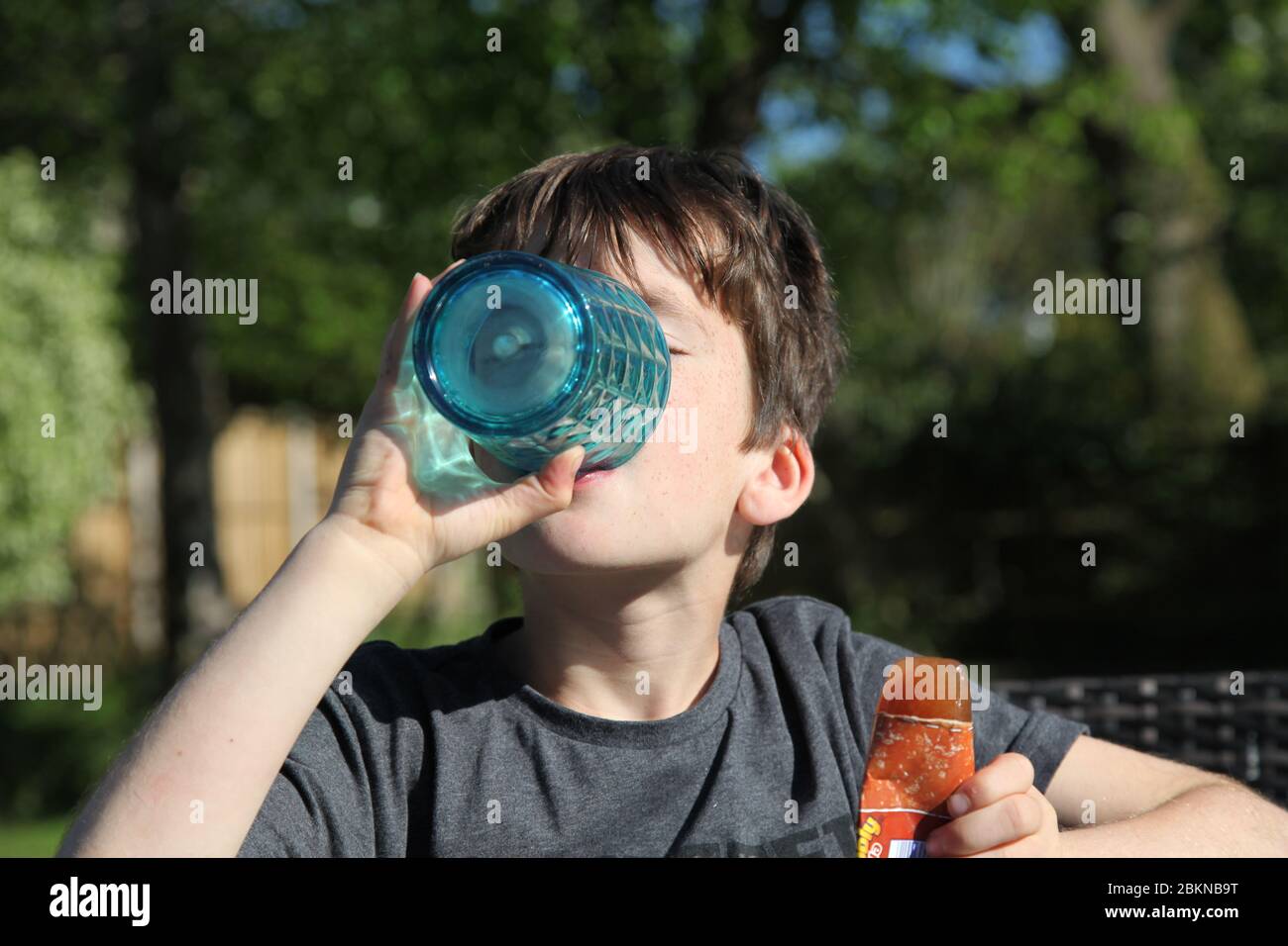 Young boy drinking from beaker hi-res stock photography and images - Alamy