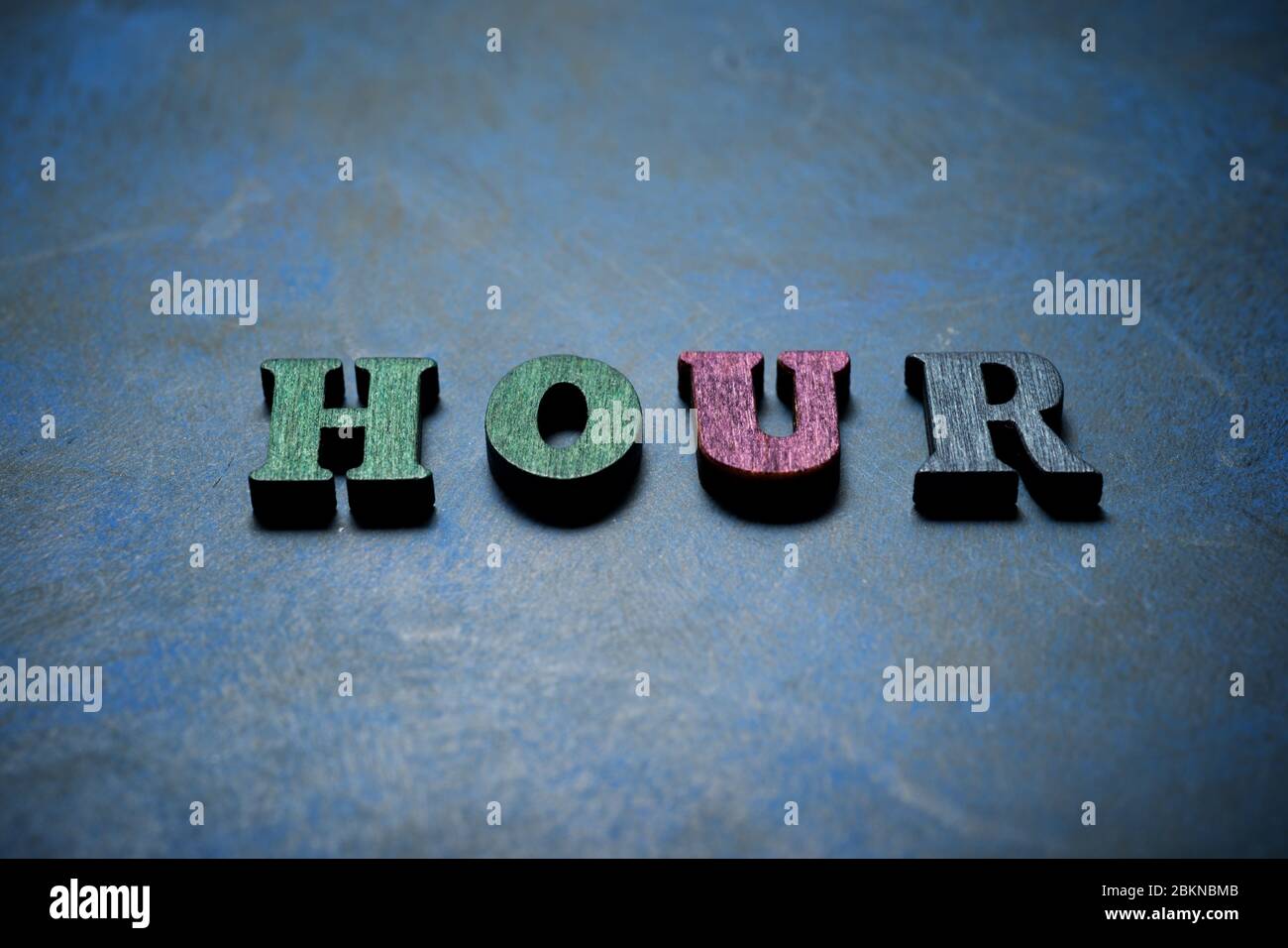 Hour word on a blue table Stock Photo - Alamy
