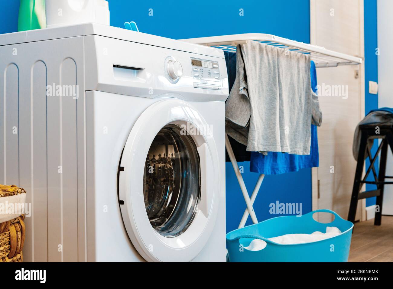 Laundry room interior with washing machine and clothes dryer near wall ...