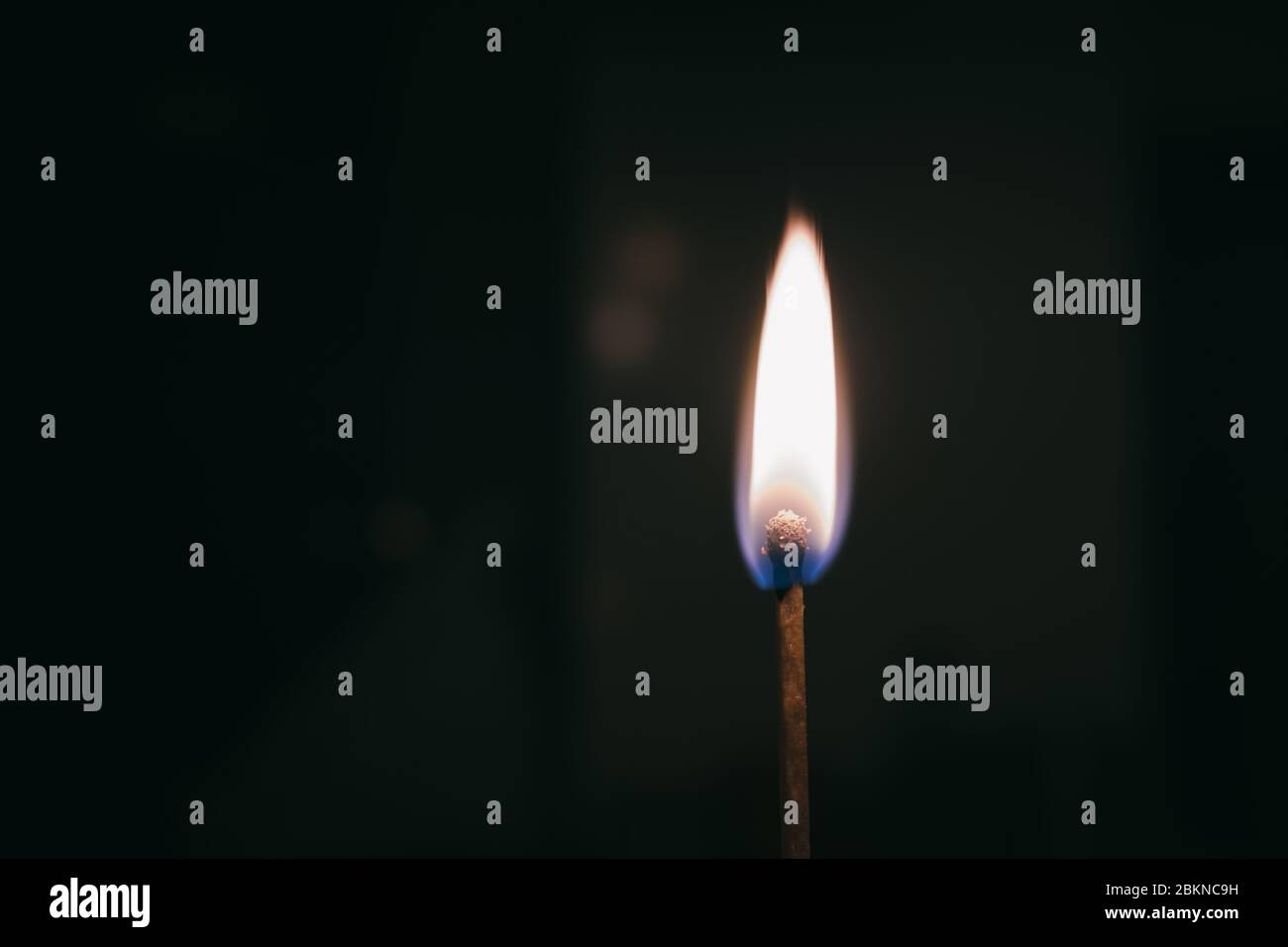 Burning flame on an isolated match stick on a black background Stock ...