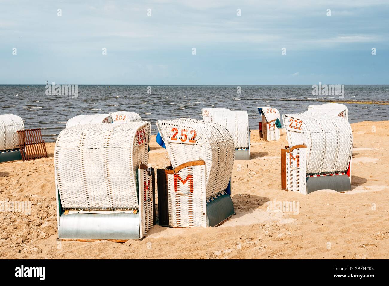 Sandy beach and typical hooded beach chairs in Cuxhaven in the North ...