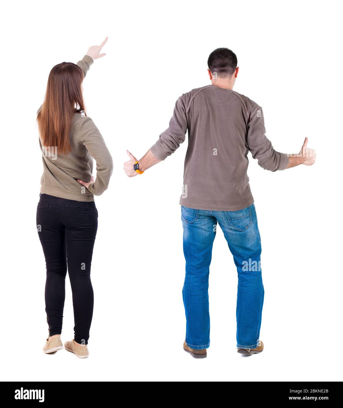 Back view of couple in sweater pointing. Rear view people collection ...