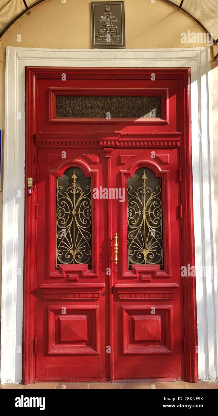 Gorgeous antique red door with ornate frames and curved metal gratings ...