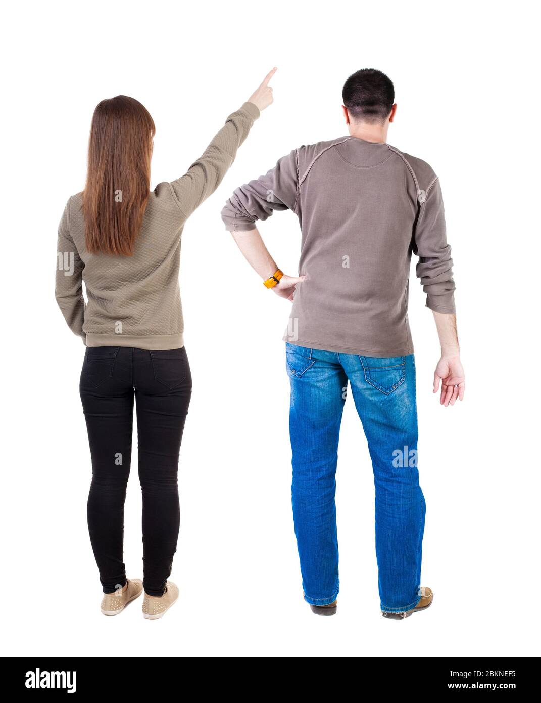 Back view of couple in sweater pointing. Rear view people collection ...