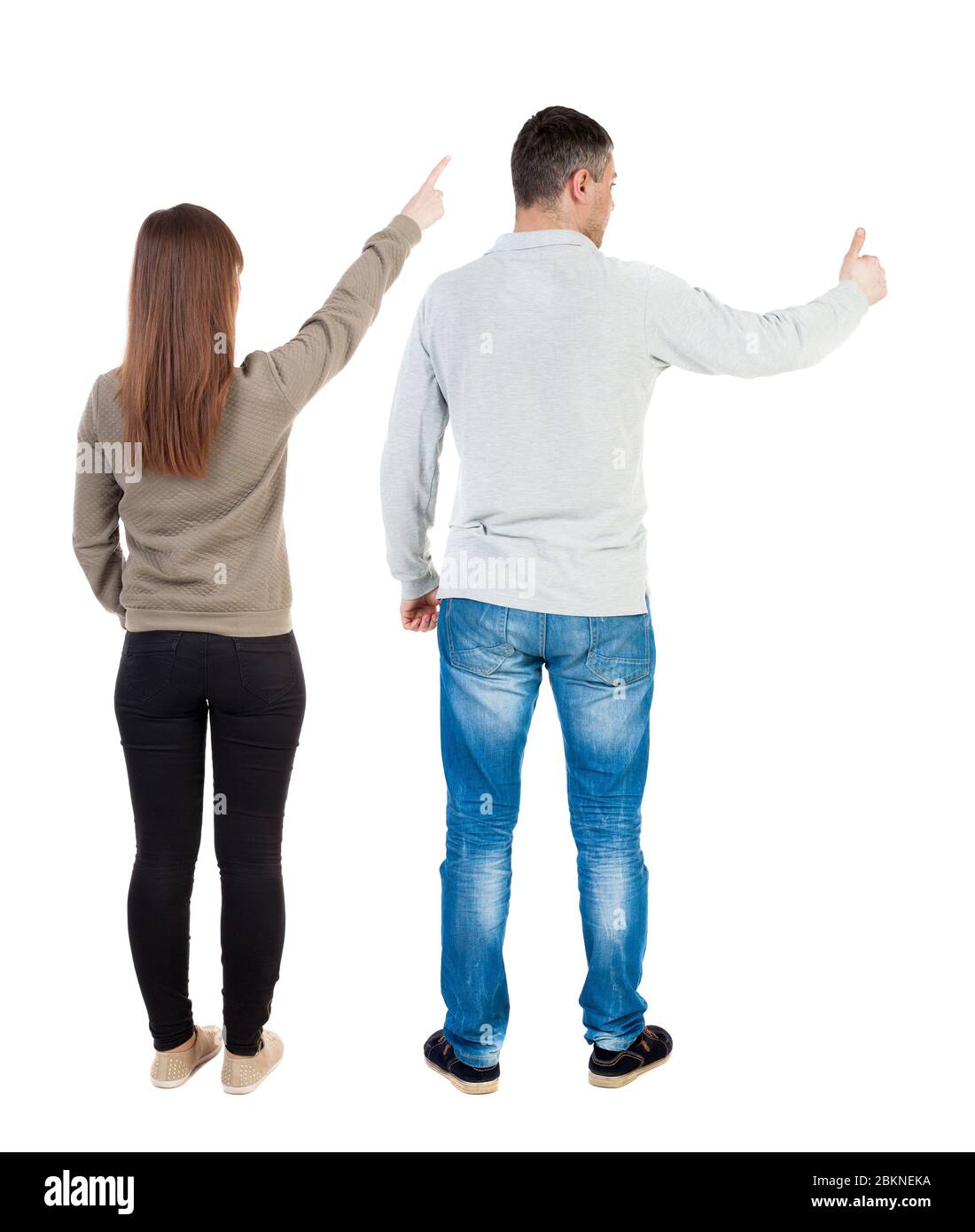Back view of couple in sweater pointing. Rear view people collection ...