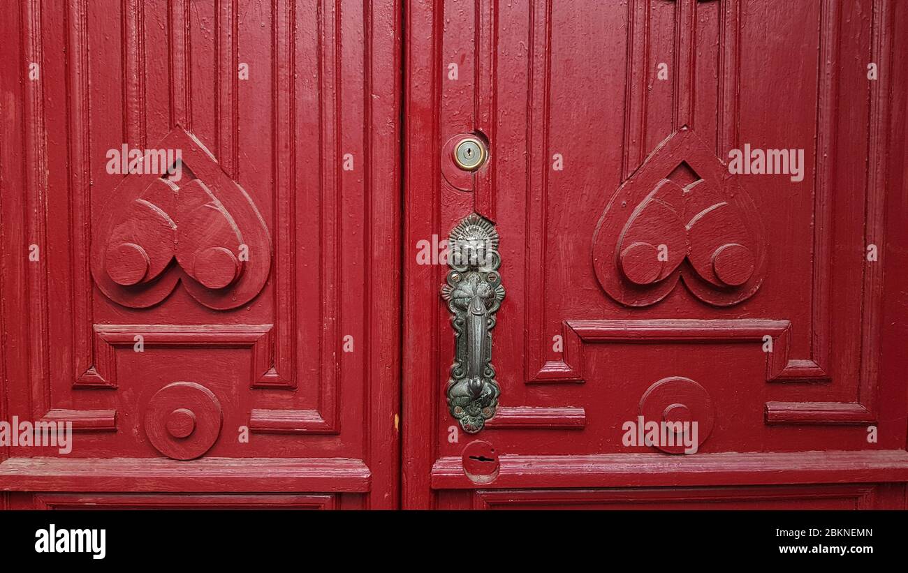 Symmetric pattern frames of red double door panels of antique door with ...