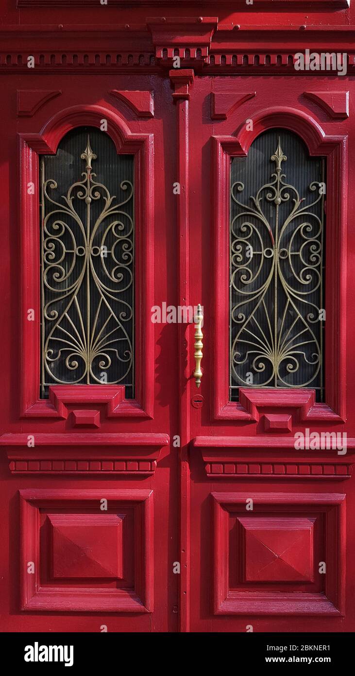Closeup of antique red door panels with ornate frames and baroque metal ...