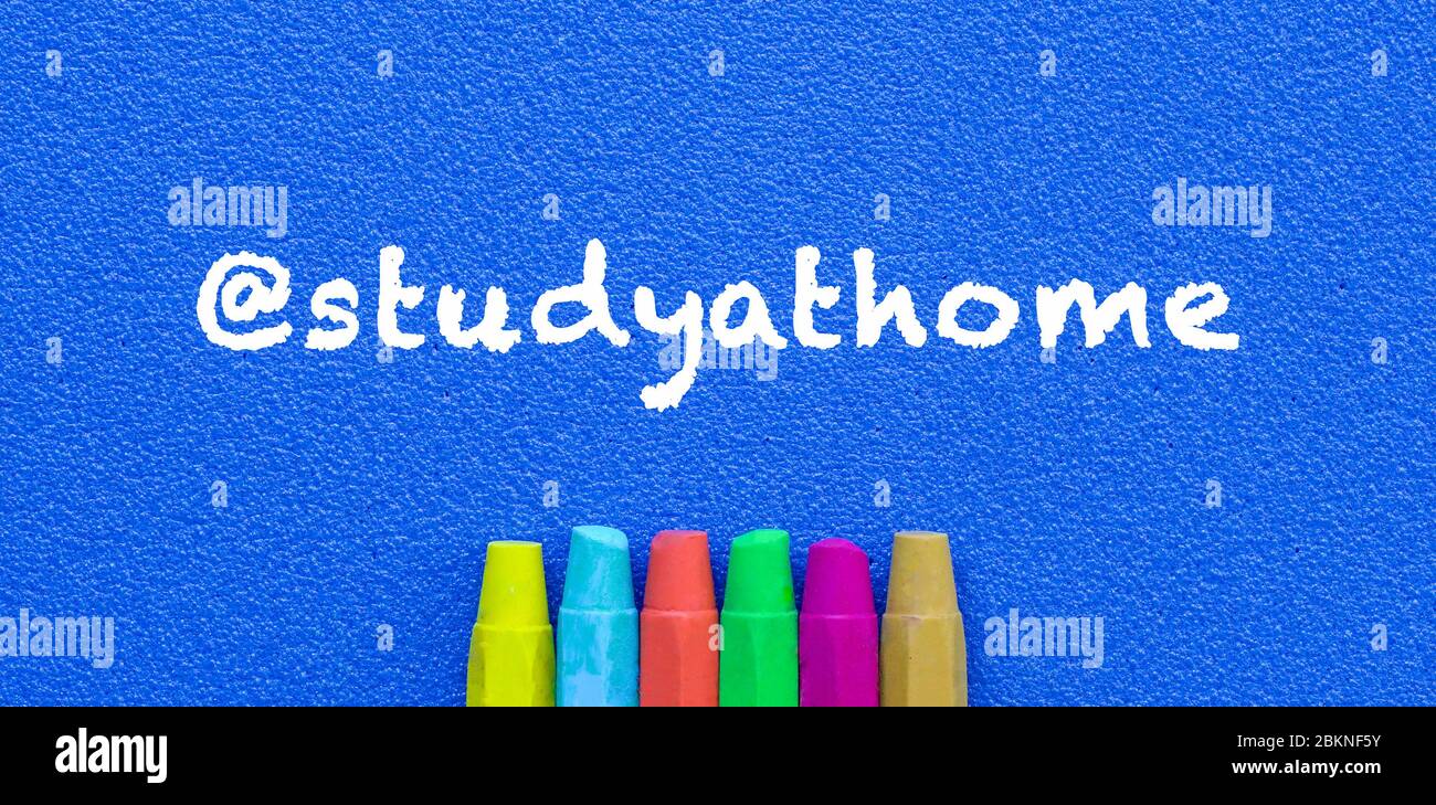 Study at home. Words or typed text on blue board. Colorful crayons. Top ...