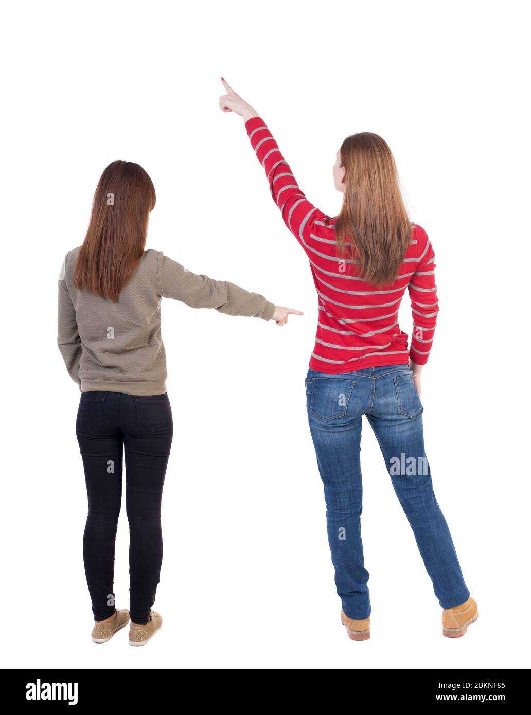 Back view of two pointing girl in sweater. Rear view people collection ...