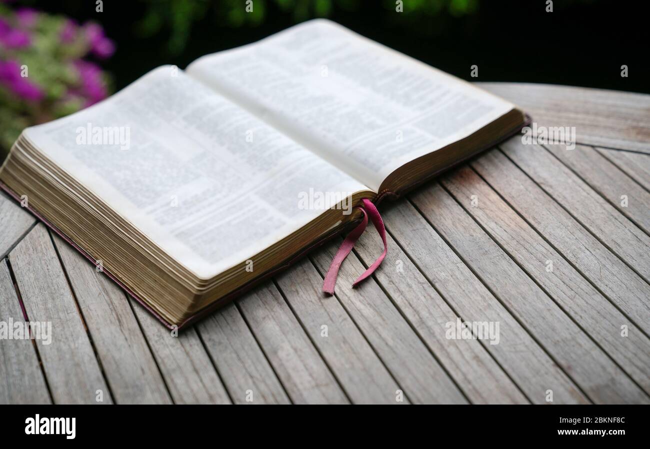 Open bible on wooden table. Soft blur effect with focus on book mark ...