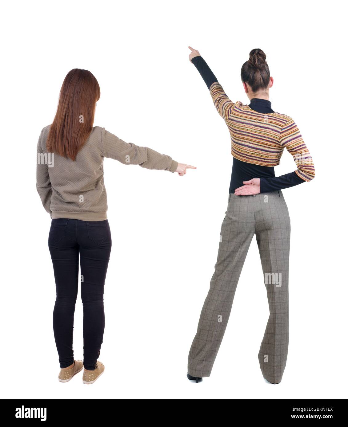 Back view of two pointing girl in sweater. Rear view people collection ...