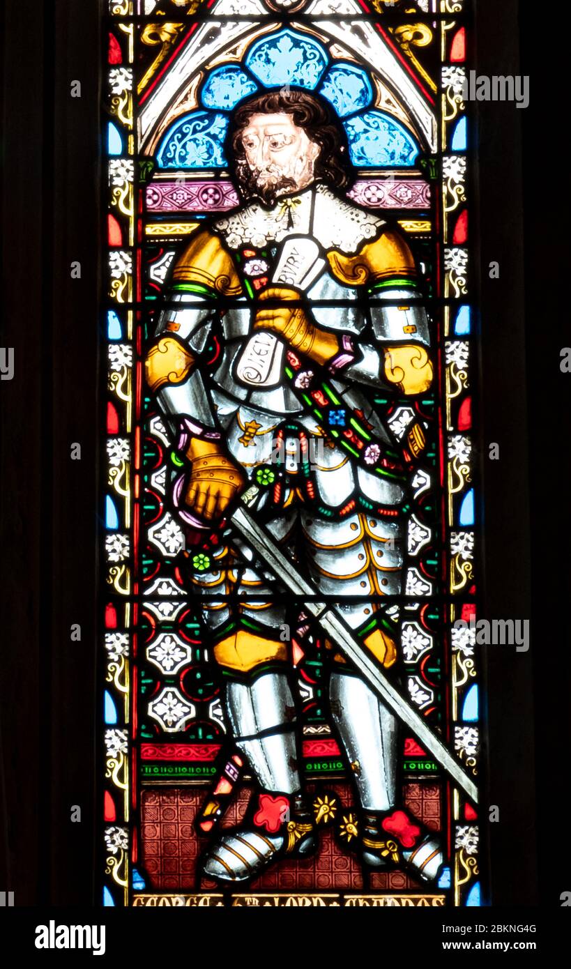 Stained glass window of a medieval knight holding a sword in the chapel ...