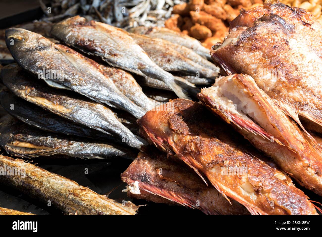 Freshly grilled fish on counter top stall, during seafood festival ...